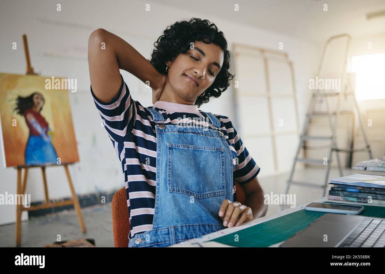 Woman artist, painter and overworked in studio with neck pain, thinking ...