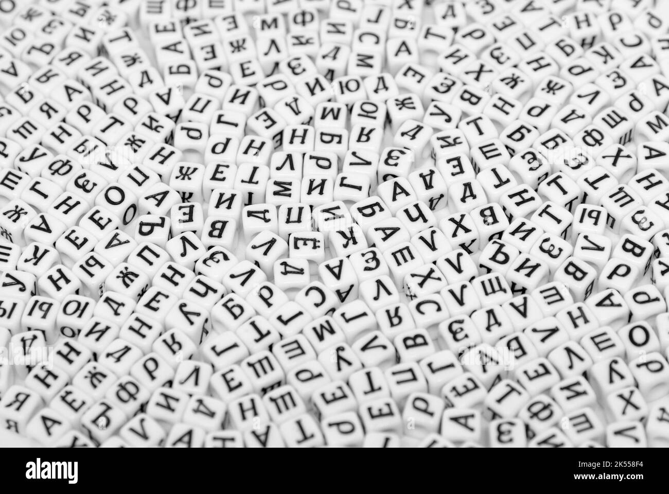 scattered cyrilic letters on white background black and white photo ...