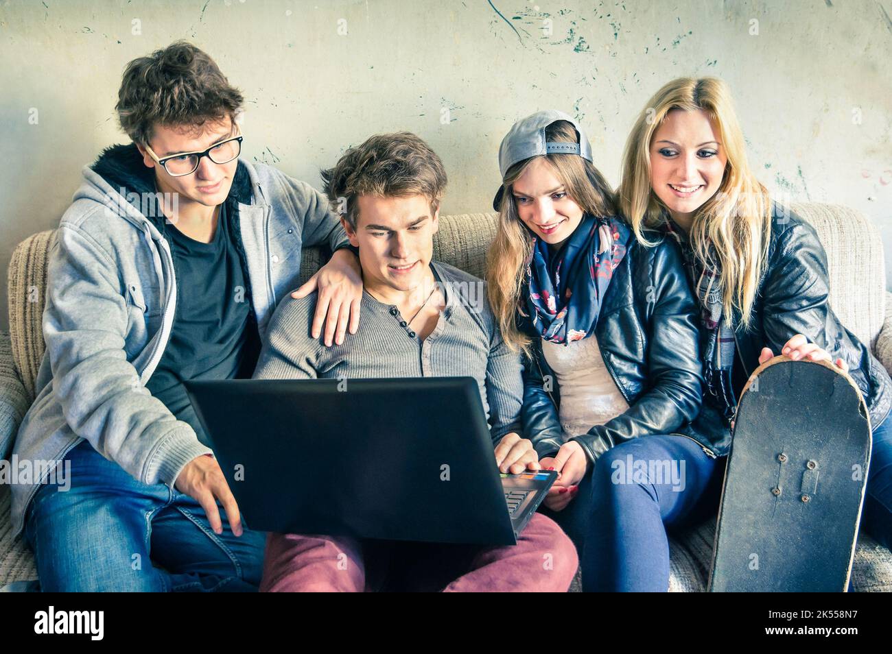 Group of young hipster best friends with computer in urban alternative ...