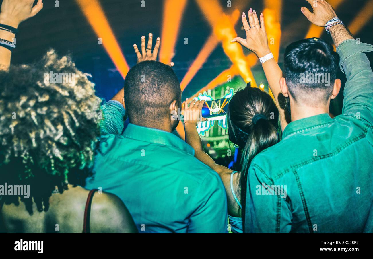 Young people dancing at night club - Hands up on laser show lights at ...