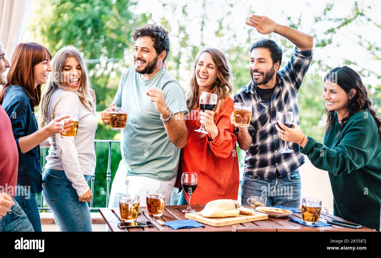 Happy friends having fun eating at house balcony dinner party - Young ...