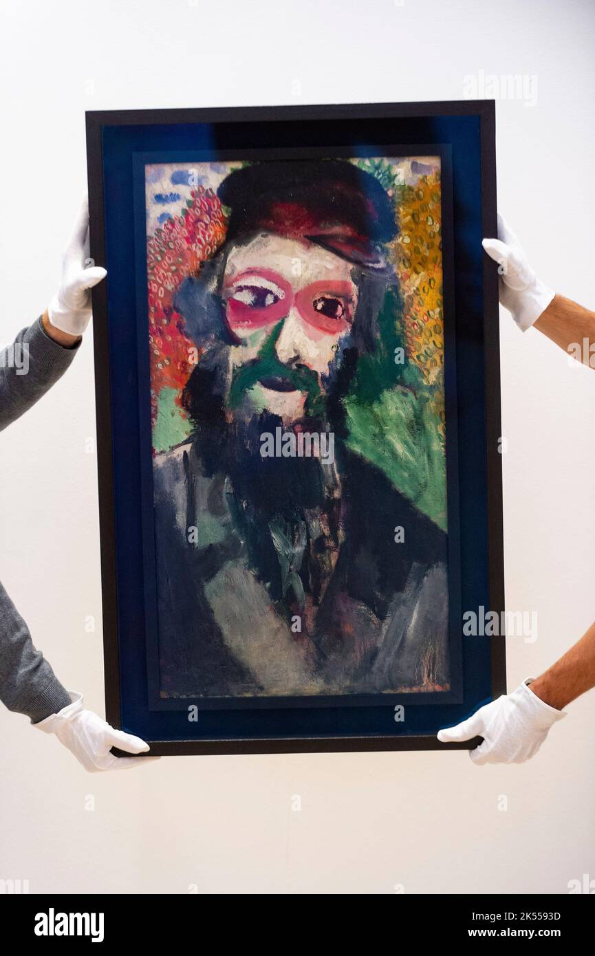 London, UK. 6 October 2022. Technicians hang Marc Chagall’s “Portrait ...
