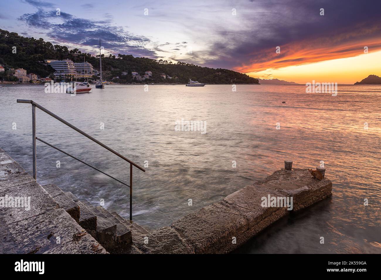 Sunset in Lopud harbour, with stairs and pier, island in Elafiti ...