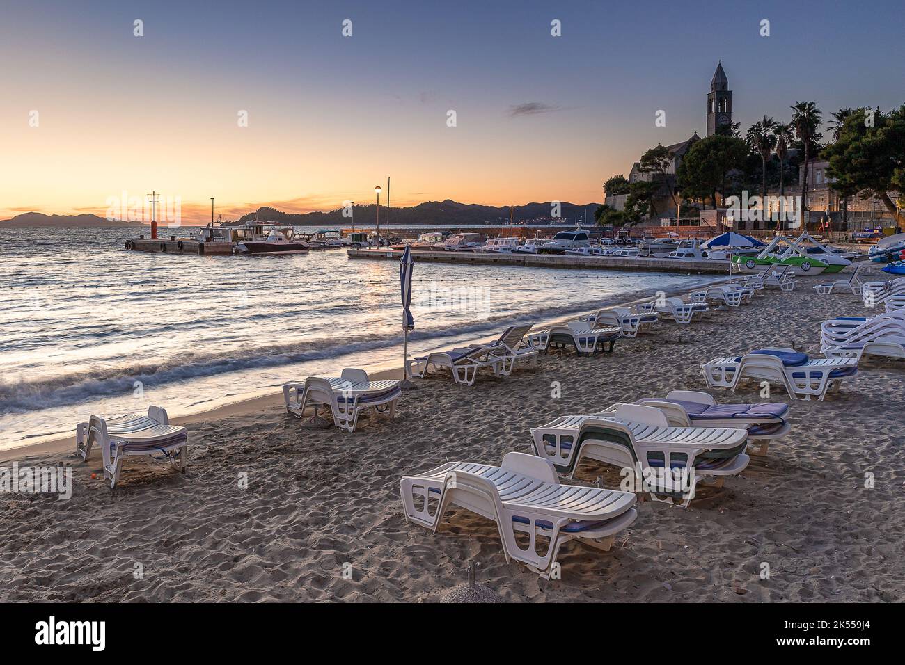 Sunset in Lopud harbour, with beach, harbour and church, island in ...