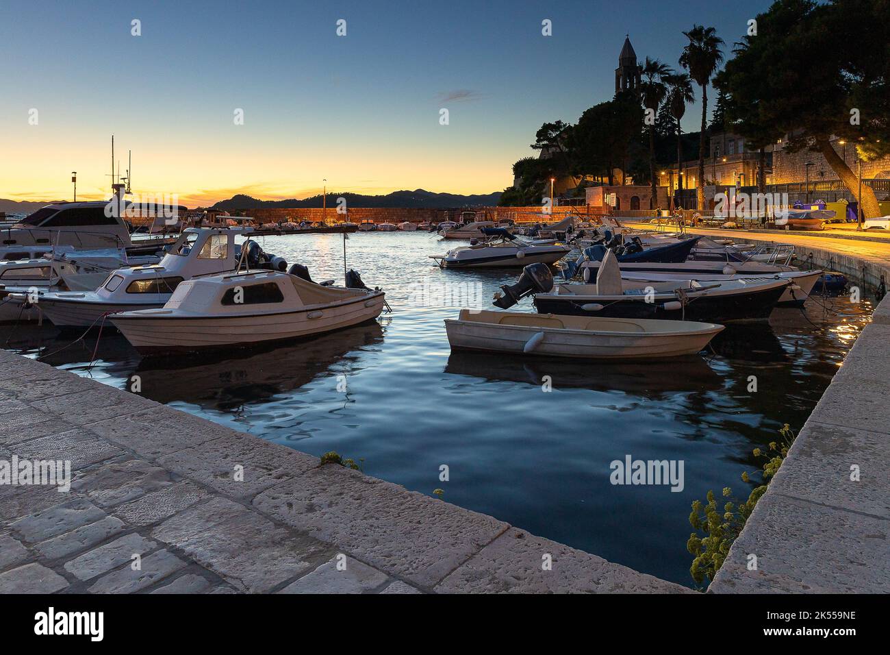 Sunset in Lopud harbour, with harbour and church, island in Elafiti ...
