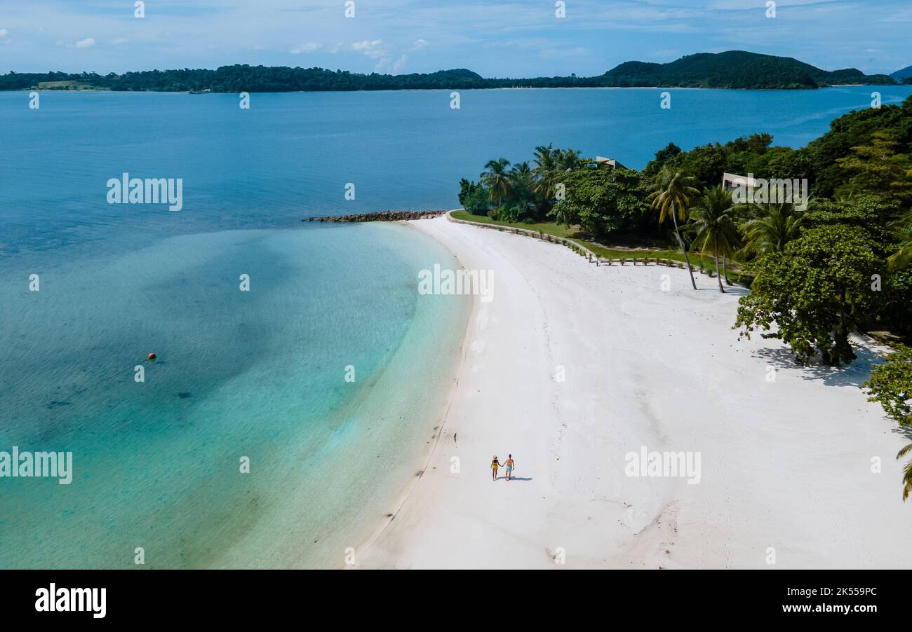 Drone aerial view couple of men and women on a tropical beach in ...