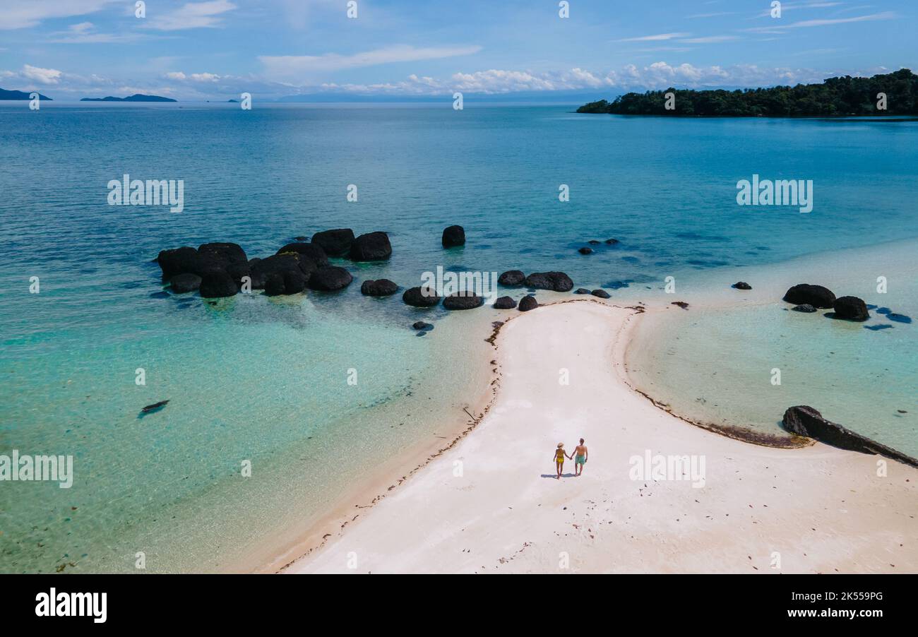 Drone aerial view couple of men and women on a tropical beach in ...