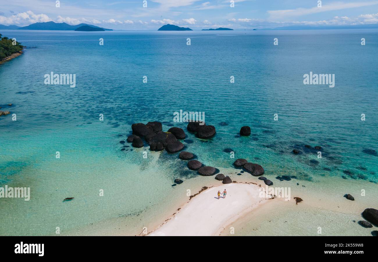 Drone aerial view couple of men and women on a tropical beach in ...