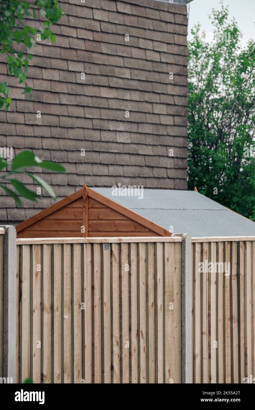 A garden shed hidden by a large fence on an urban housing estate Stock ...