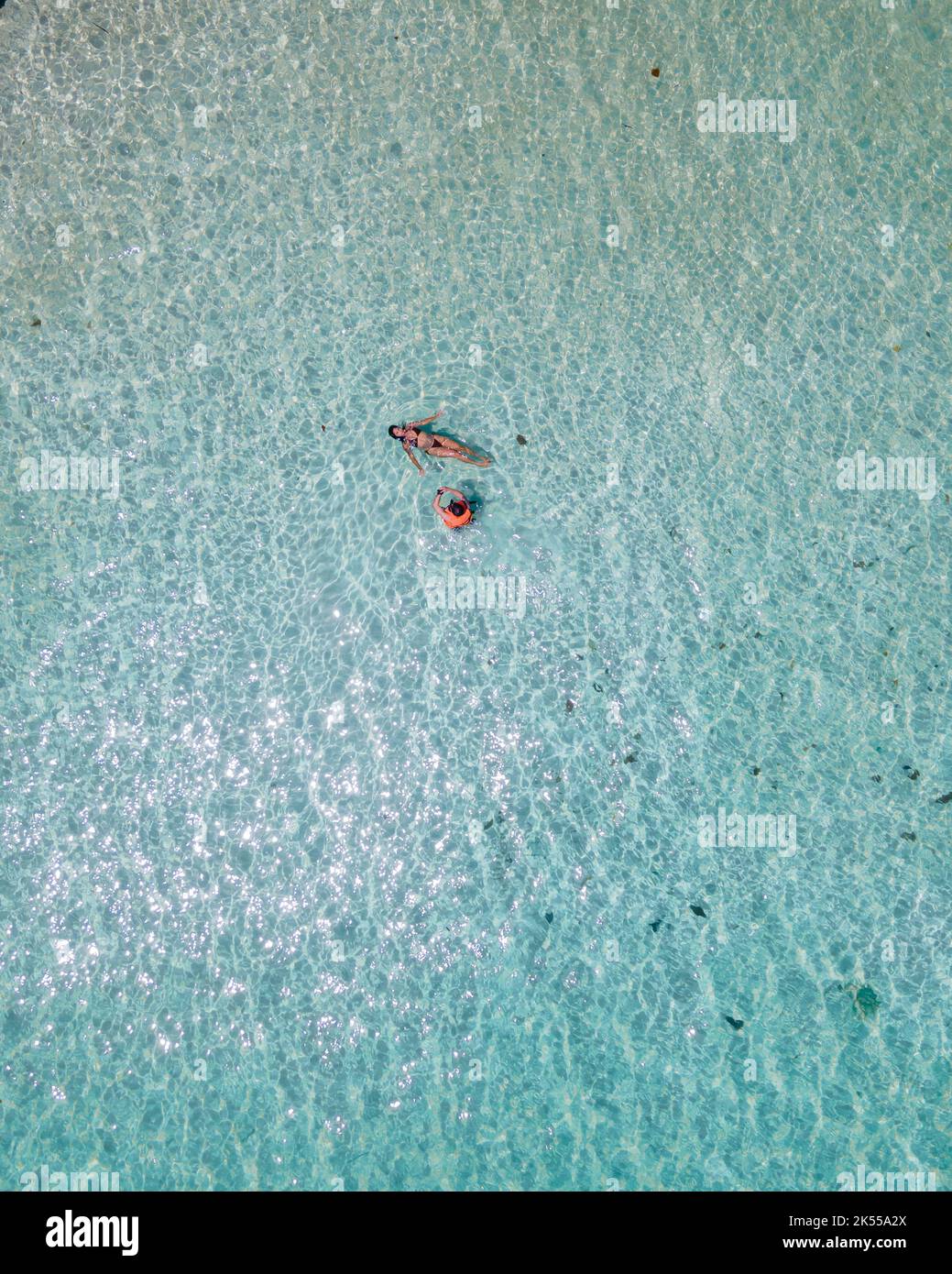 Drone aerial view couple of men and women on a tropical beach in ...