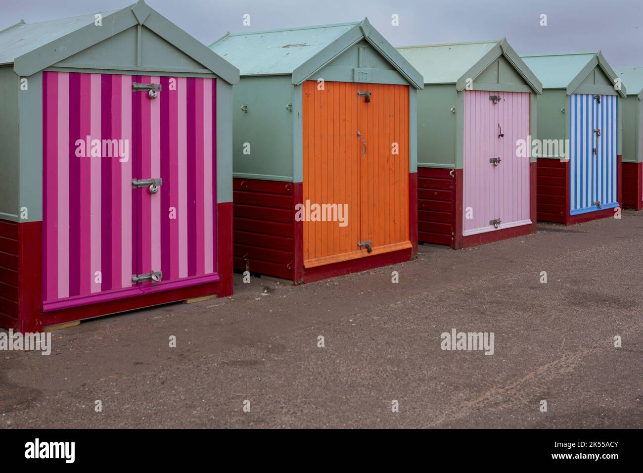 A line of beach huts in the twilight Stock Photo - Alamy