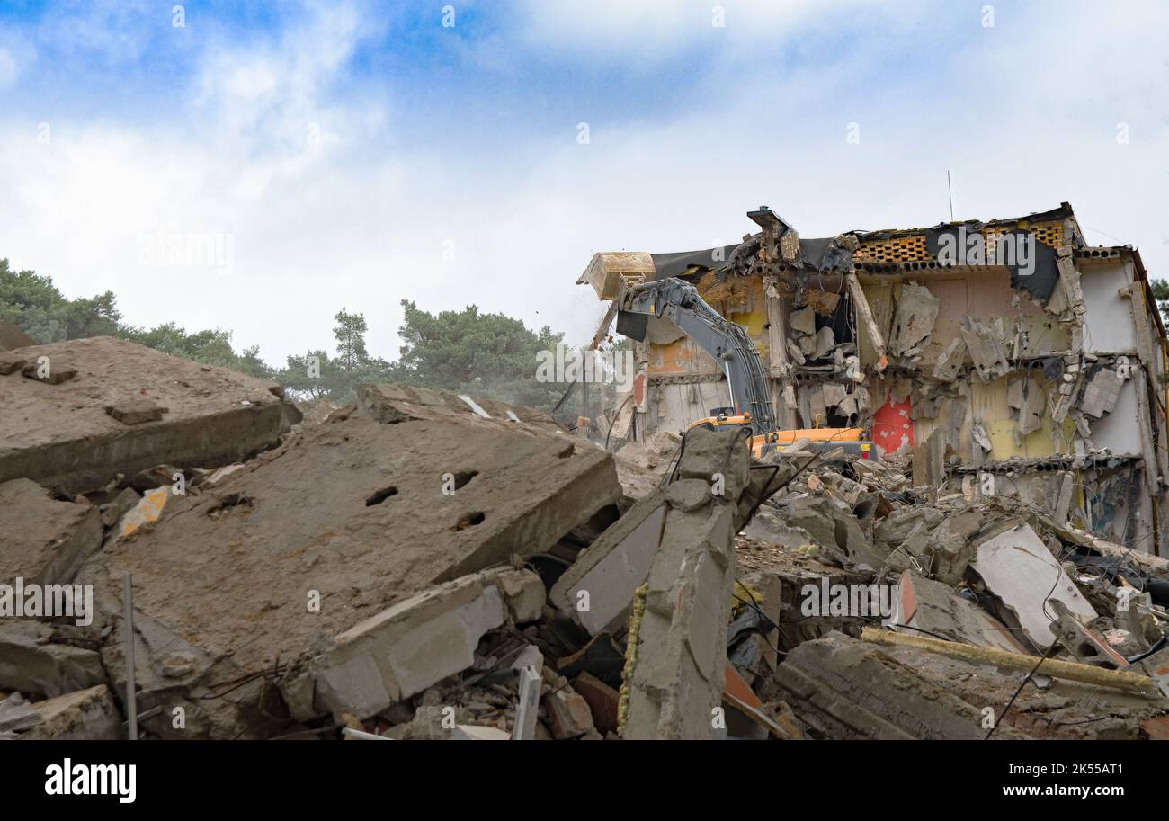 Process of demolition of old building dismantling. Excavator breaking ...