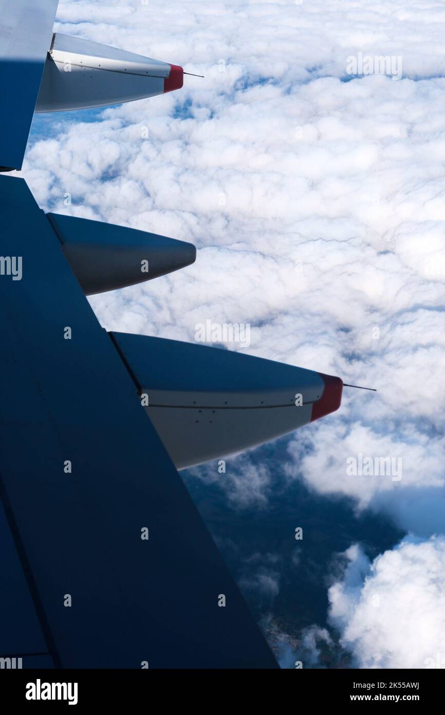 Looking out of the window of an aeroplane at the wing with dramatic ...