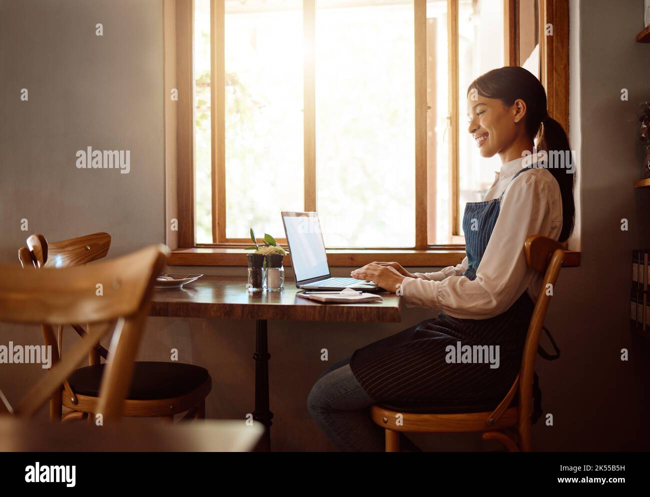 Female, coffee shop owner and laptop restaurant worker on a work break ...