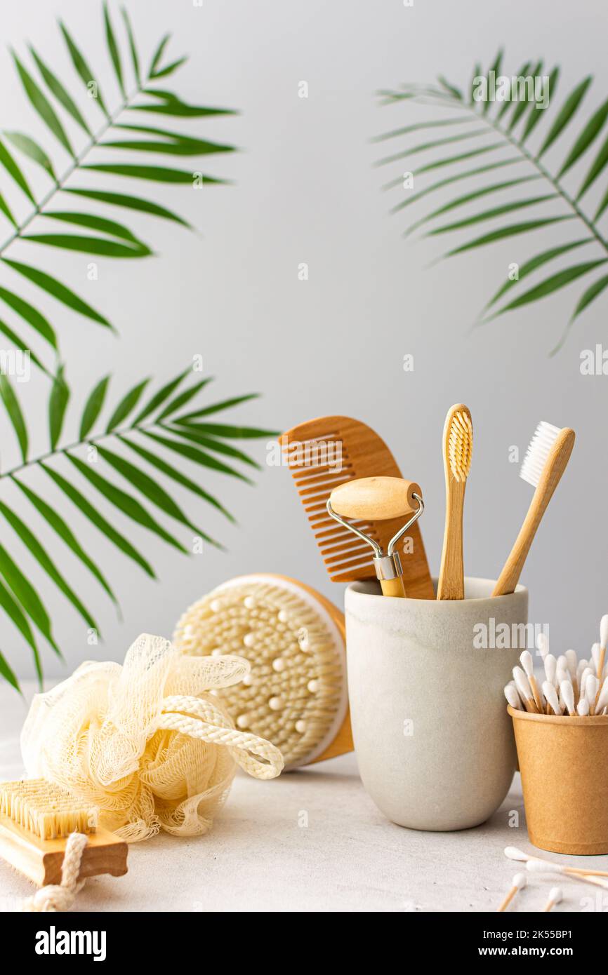 Wooden toothbrushes with natural bristles in a ceramic glass, face and ...
