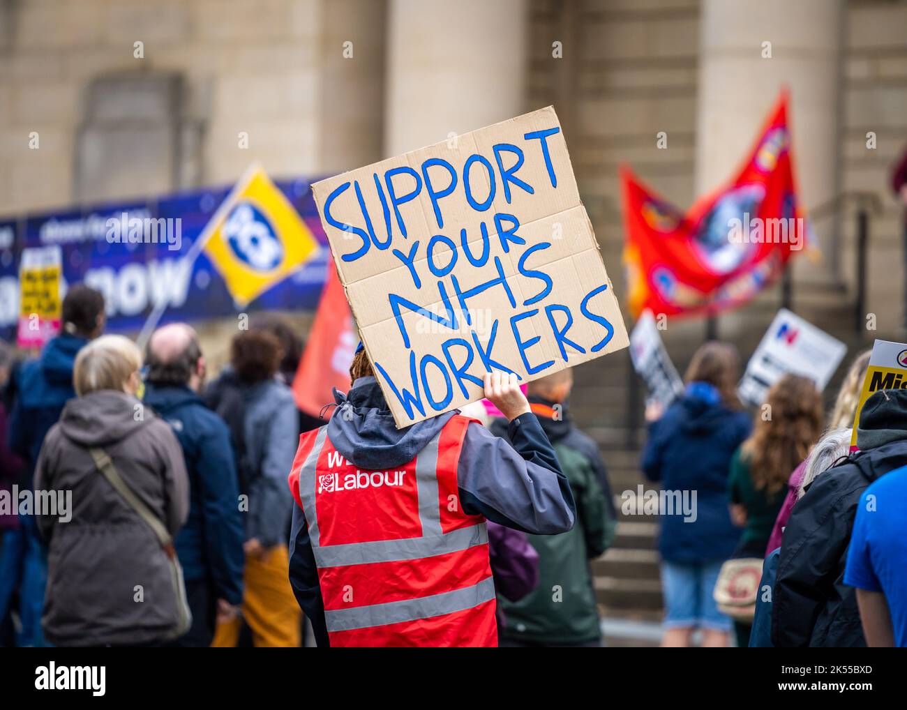UK NHS Nurses strike action due to lack of pay rises. Holding signs and ...