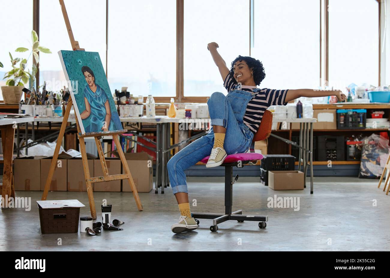 Art, happy and excited woman with painting in studio or design school smiling at finished ...