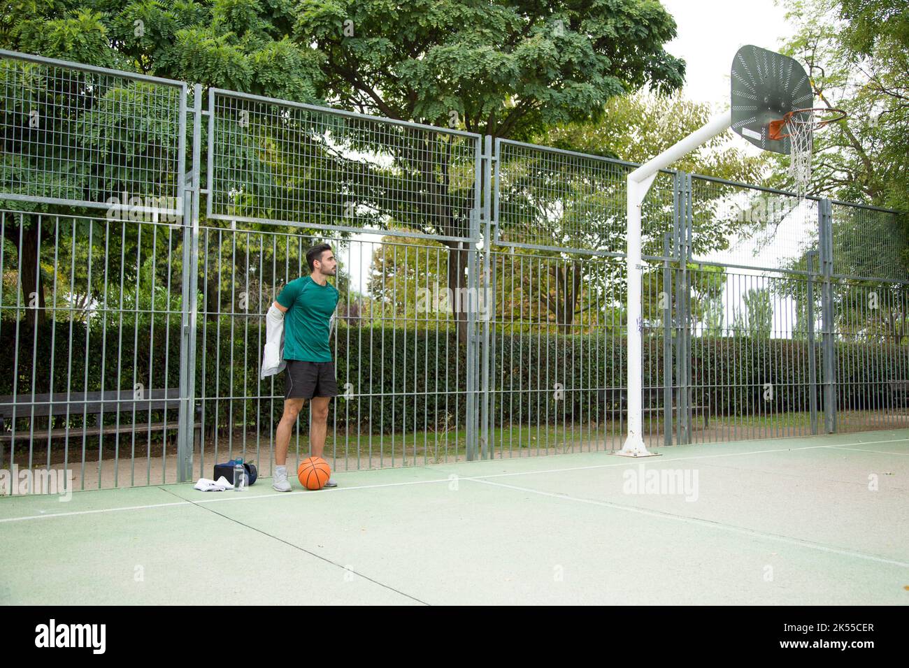 Basketball player taking off his sweatshirt to enter the court to play ...