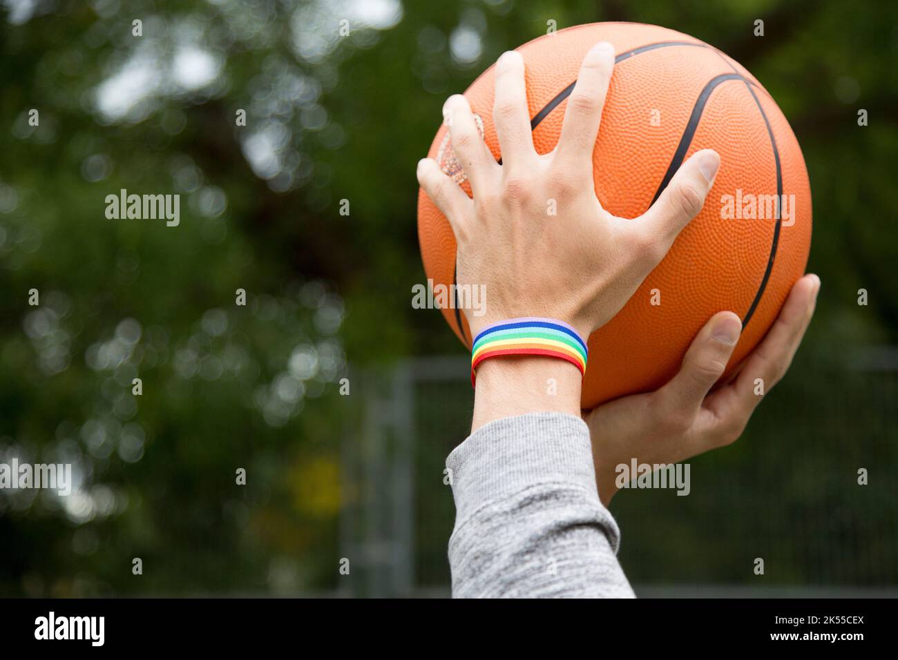 Person holding a rainbow flag hi-res stock photography and images - Alamy