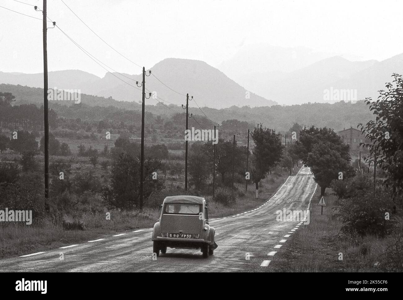 Citroen 2CV driving along a French country road Stock Photo - Alamy