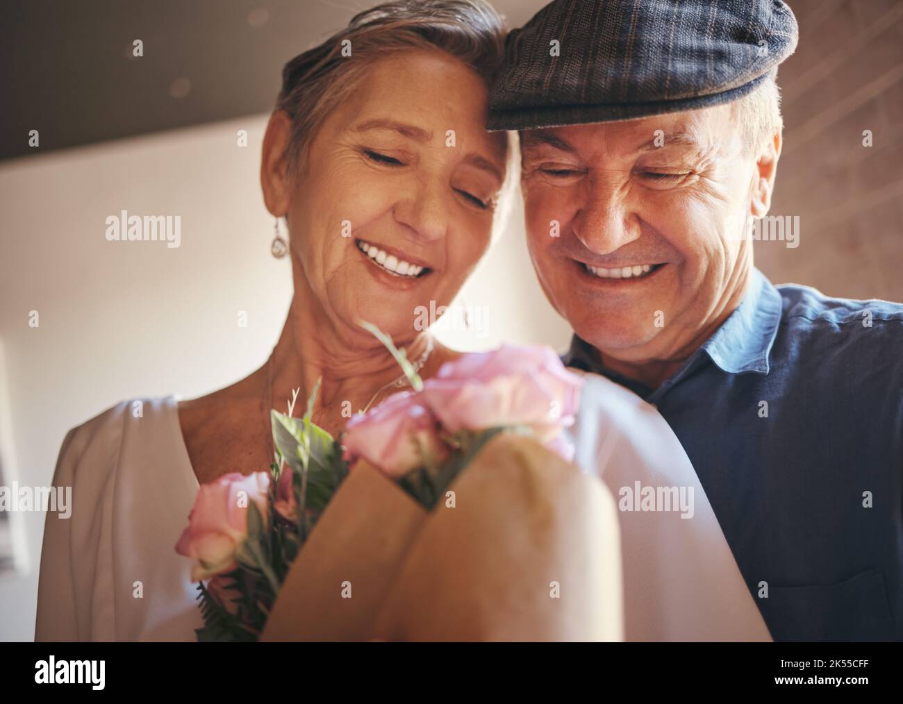 Love, hug and old couple with flowers as a gift in celebration of a ...