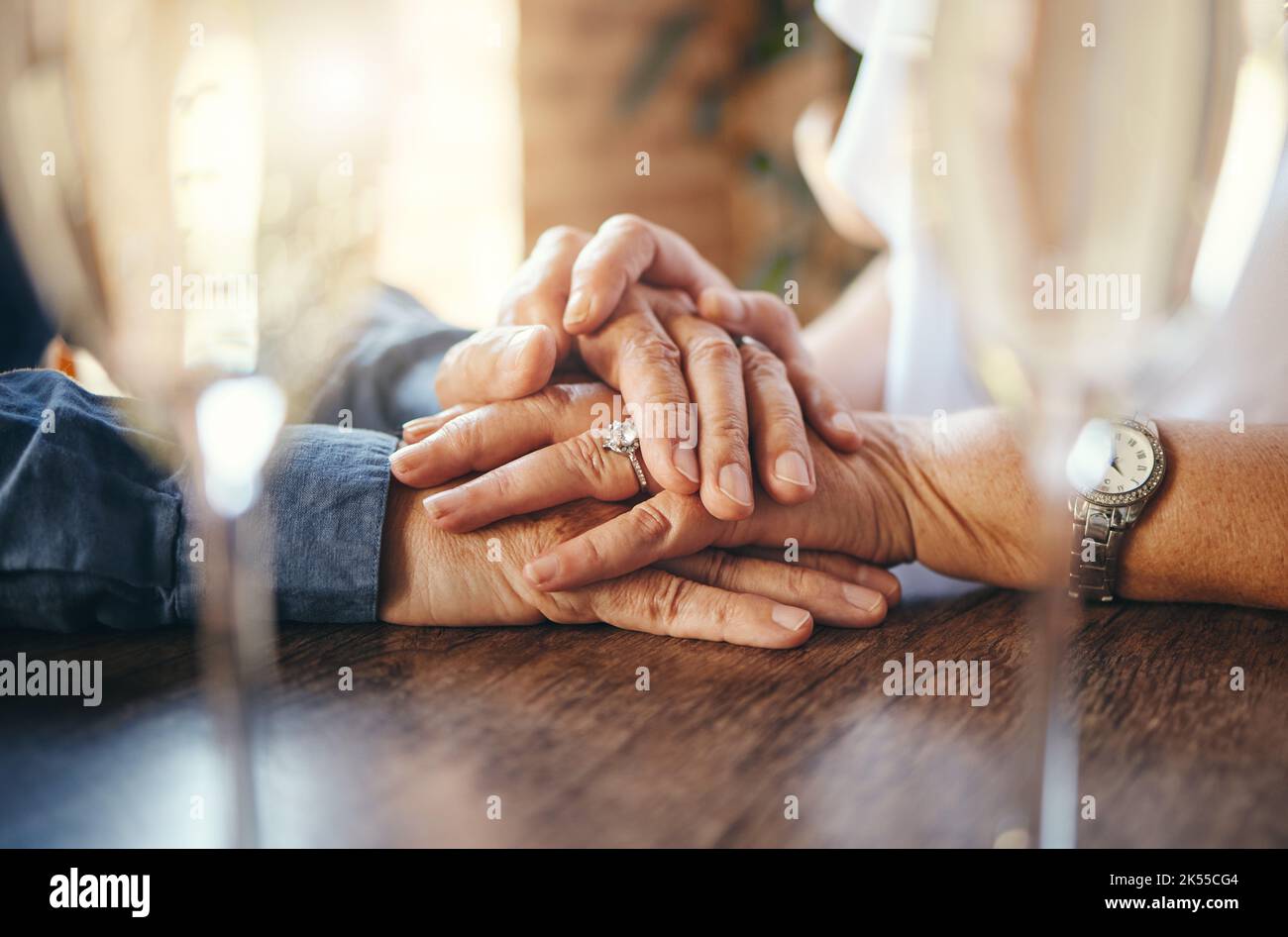 Old couple holding hands, love and support on restaurant date ...