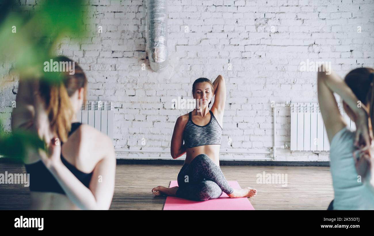 Professional Friendly Yoga Teacher Is Demonstrating Arm Locks In Cow