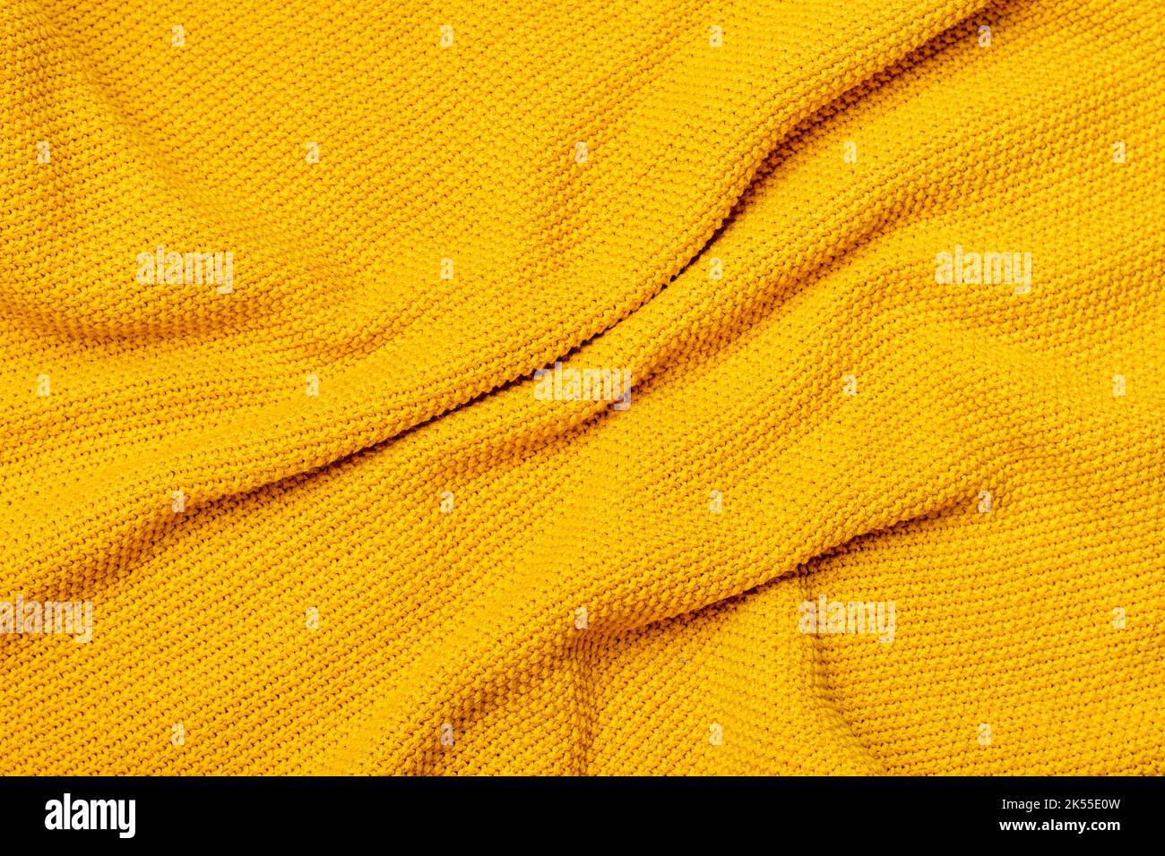 Bright yellow macro photo of textured jersey and knitting of sweater or ...