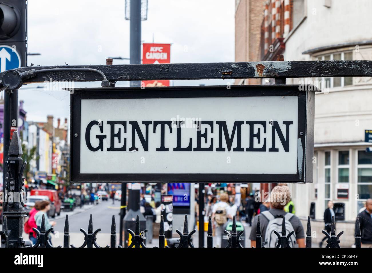 Illuminated 'Gentlemen' sign above the gents' public convenience, or ...