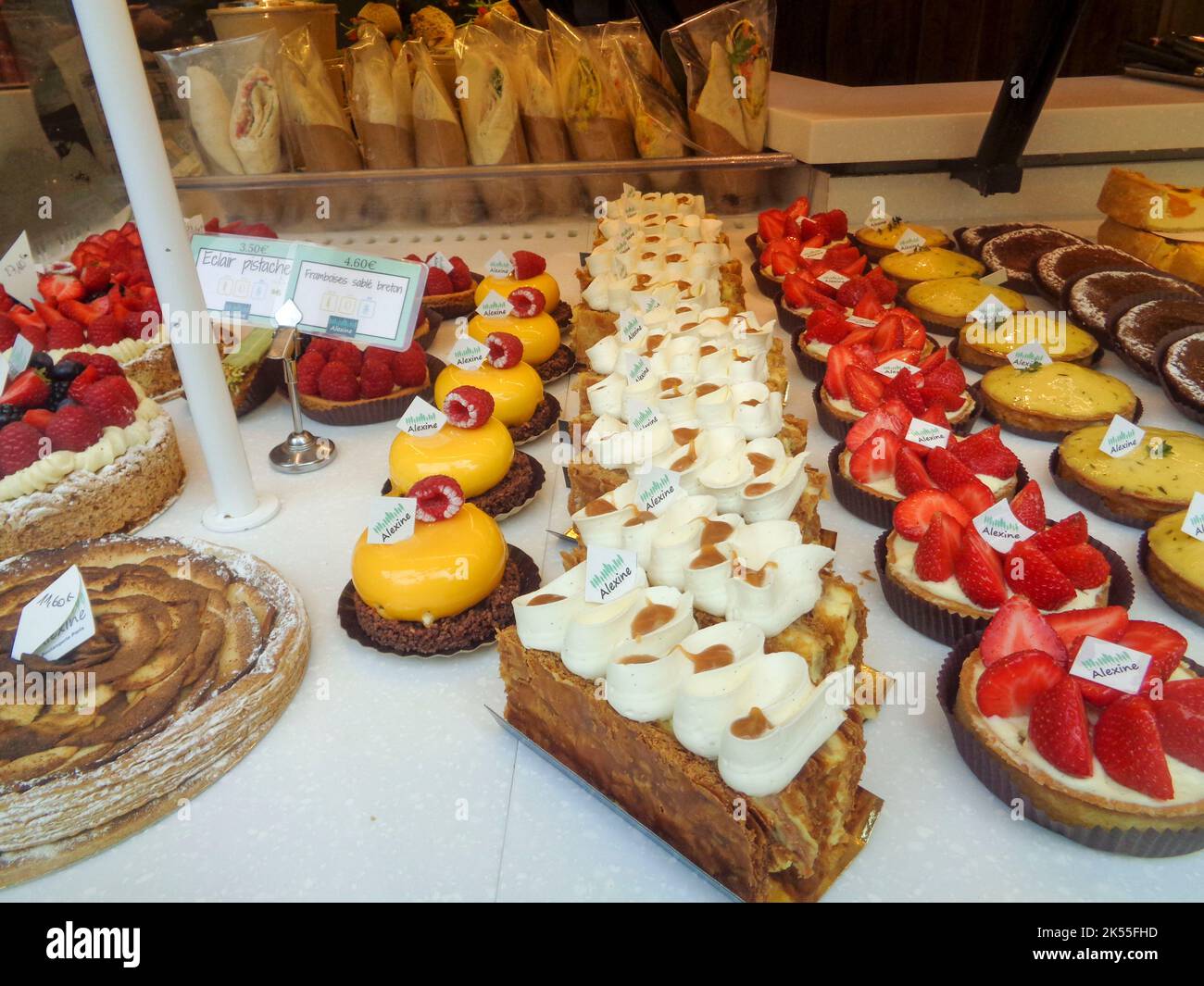 Delectable sweet goods through a Paris pâtisserie window, France Stock ...