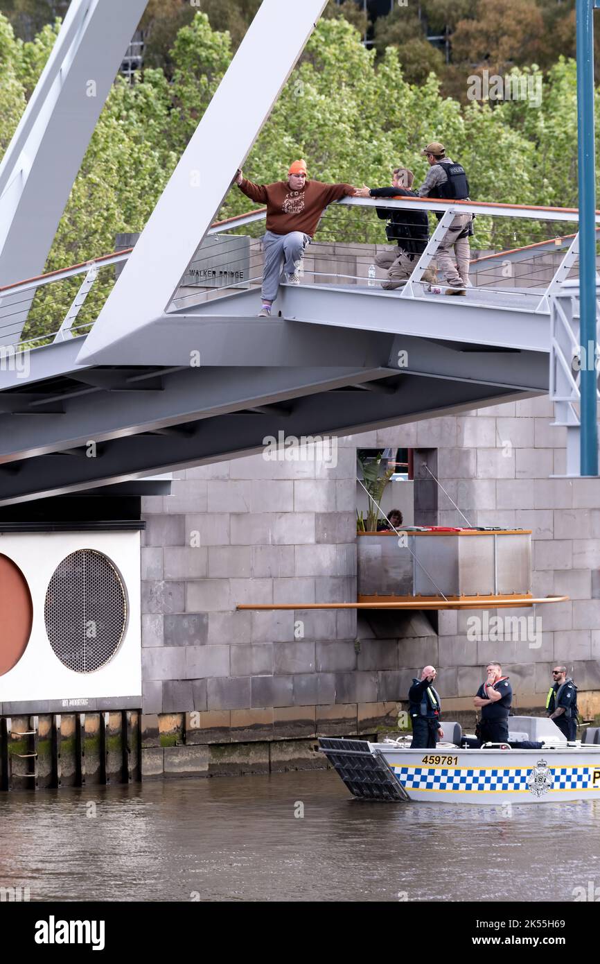 Melbourne, Australia, 6 October, 2022. A police negotiator speaks to a ...