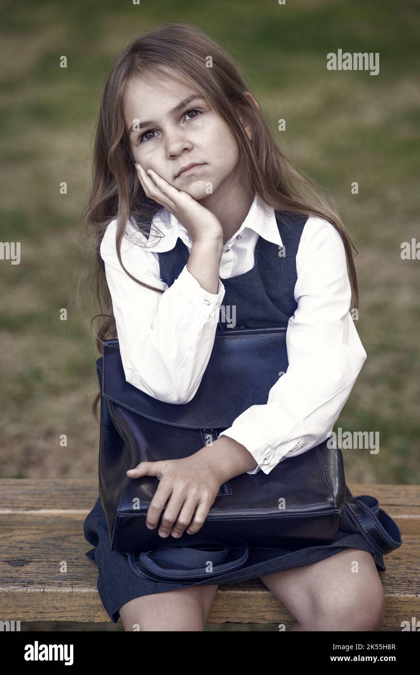 Learn to think. Serious child with thoughtful look. Small pupil lost in ...