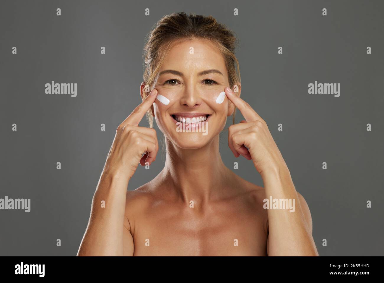 Mature woman, face cream and skincare beauty, cosmetics and gray studio ...