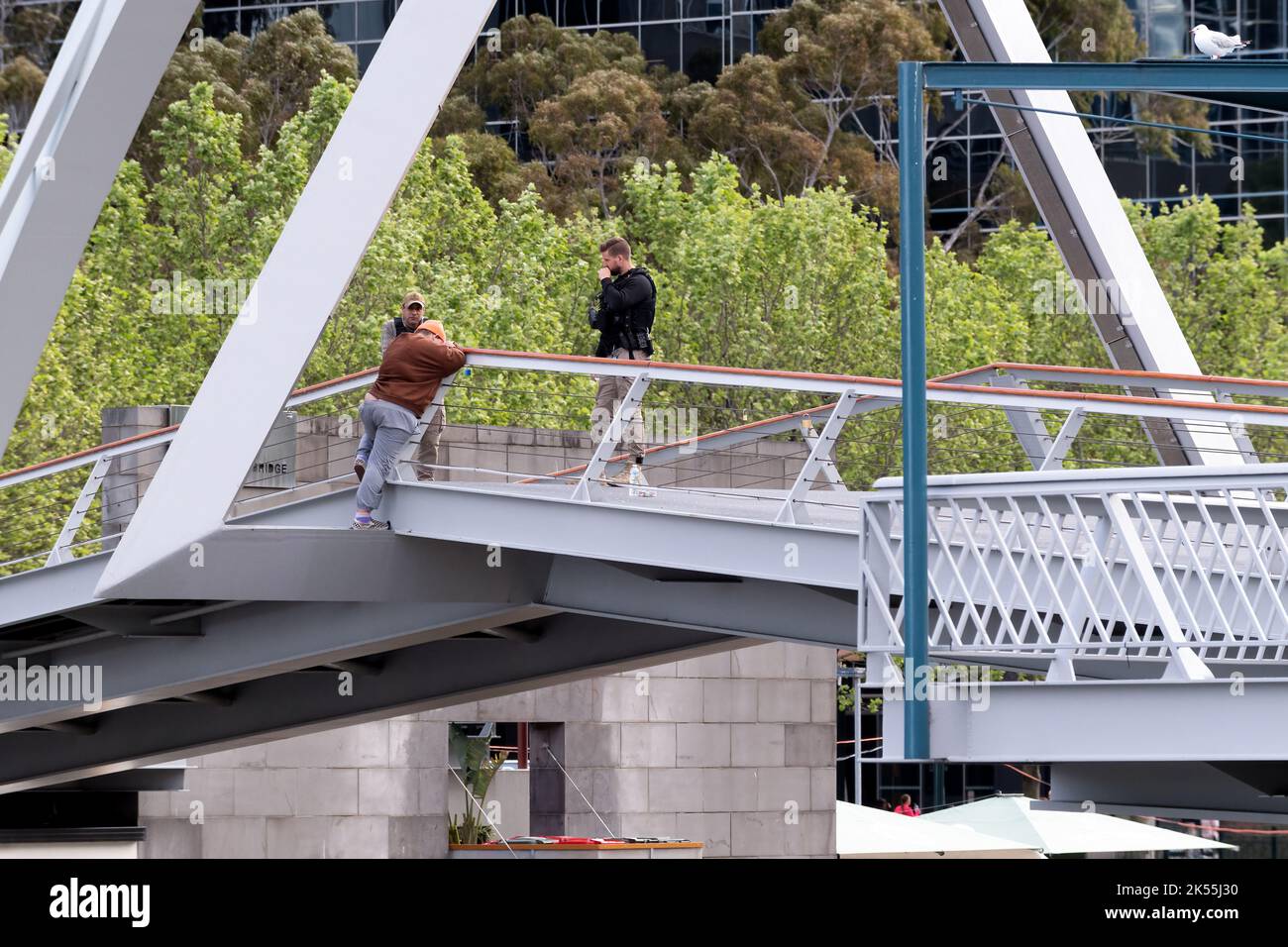 Melbourne, Australia, 6 October, 2022. A police negotiator speaks to a ...