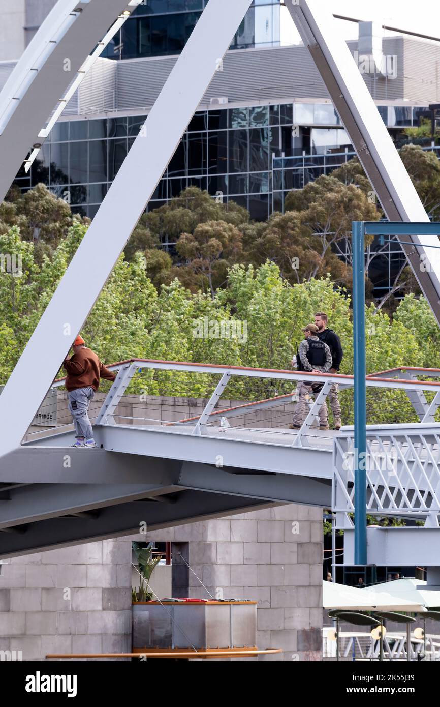 Melbourne, Australia, 6 October, 2022. A police negotiator speaks to a ...