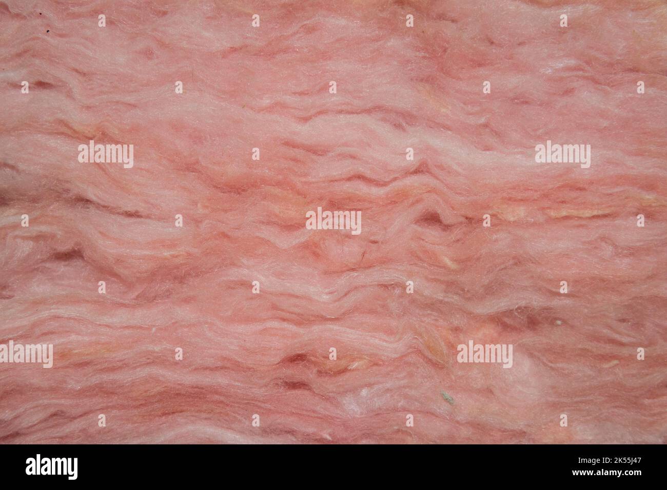 Closeup view of layers of pink fiberglass insulation Stock Photo - Alamy