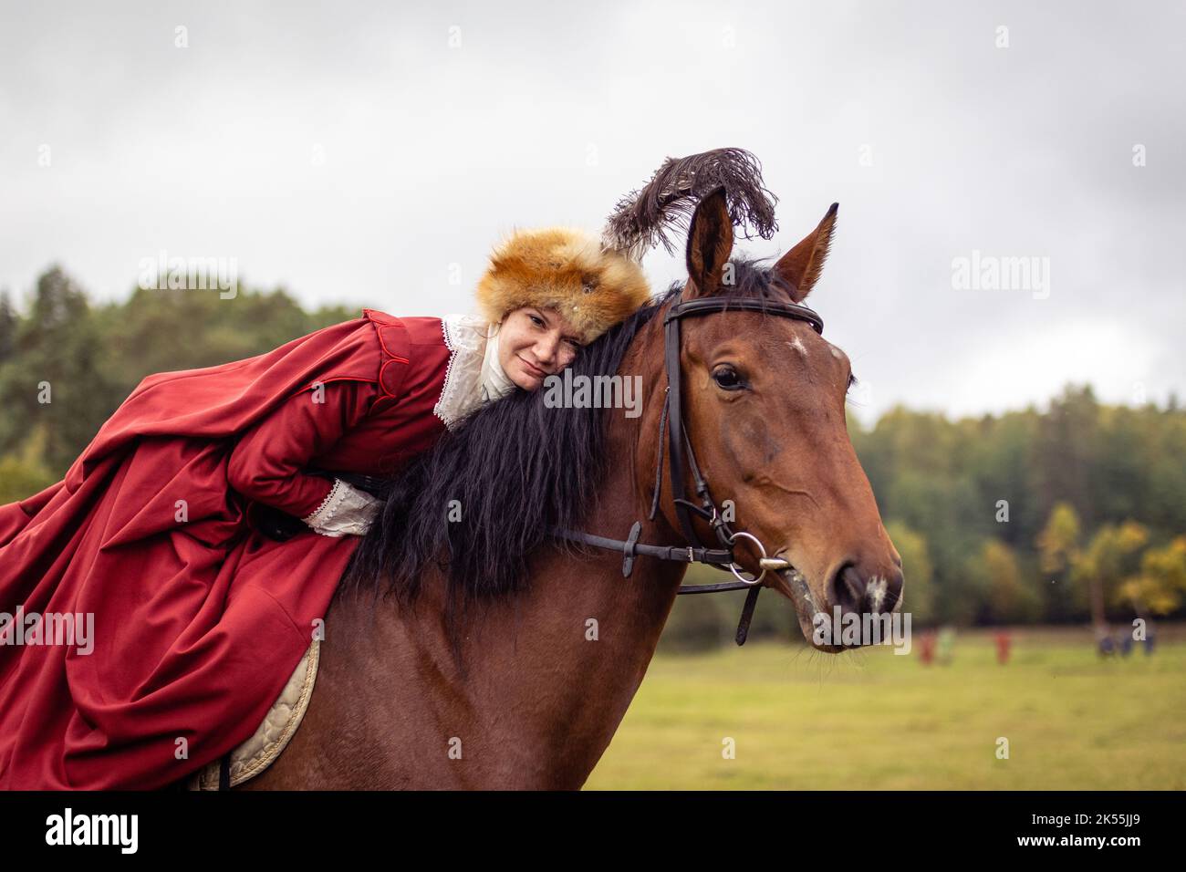 Woman in red dress riding horse hi-res stock photography and images - Alamy