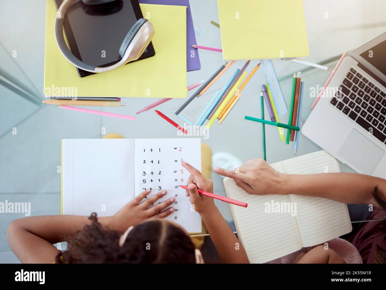 Home school, kid and mother writing math homework of numbers, education ...