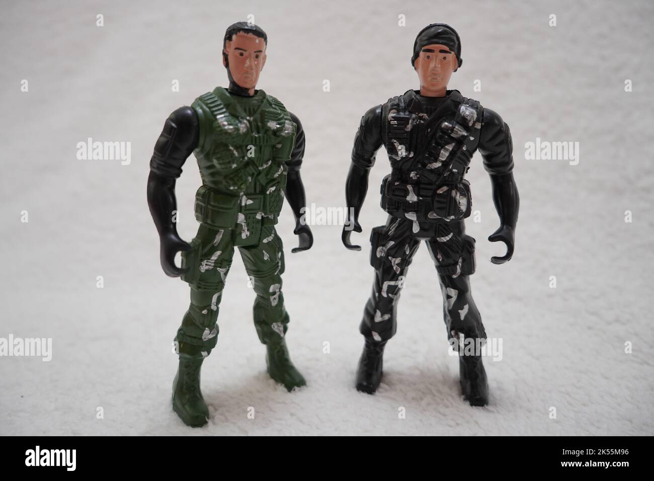 two soldier figurines arguing concept. armymen in green combat uniform ...