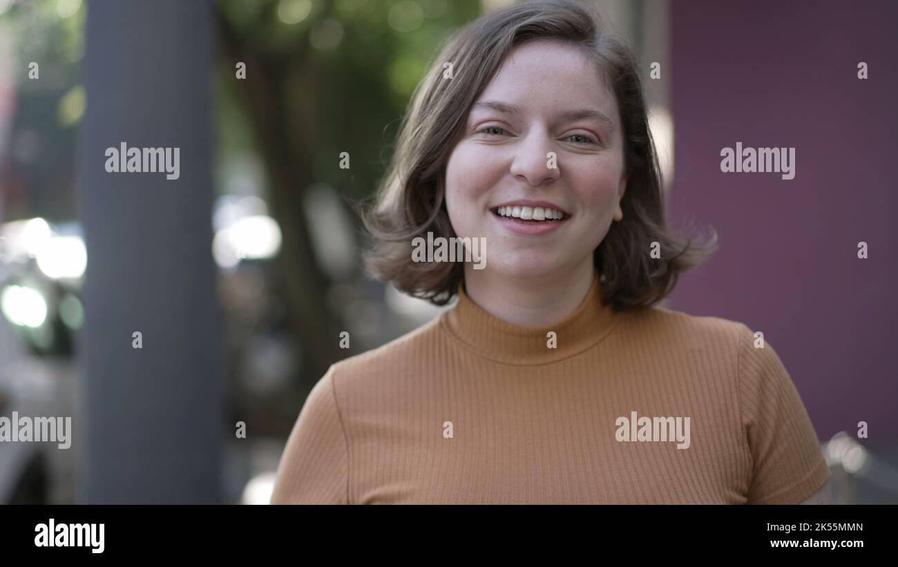 Portrait of a joyful woman walking toward camera. Tracking motion shot ...