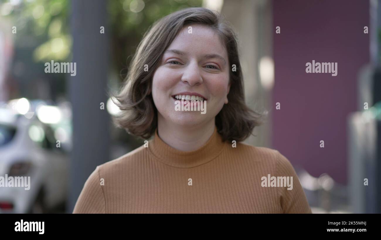 Portrait of a joyful woman walking toward camera. Tracking motion shot ...