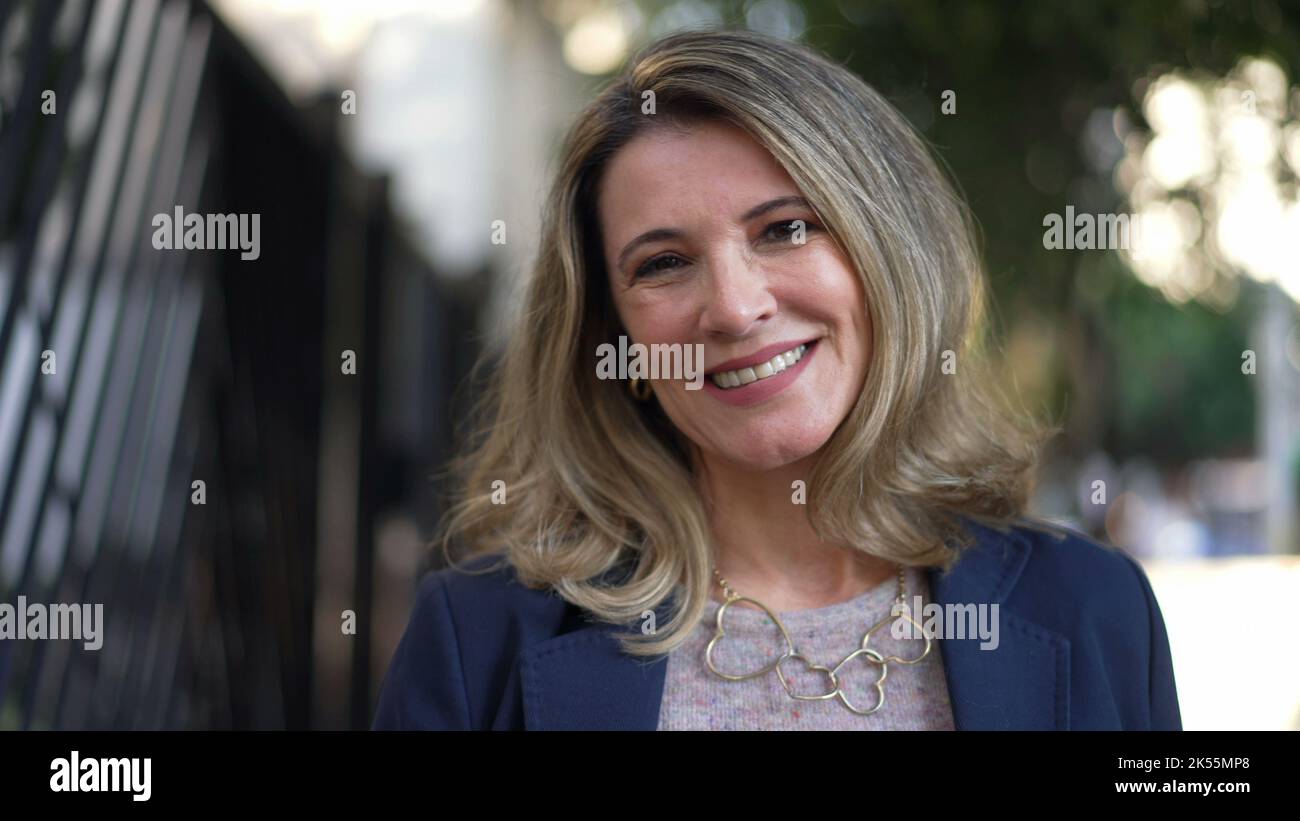Portrait of an attractive middle age older woman walking forward in ...