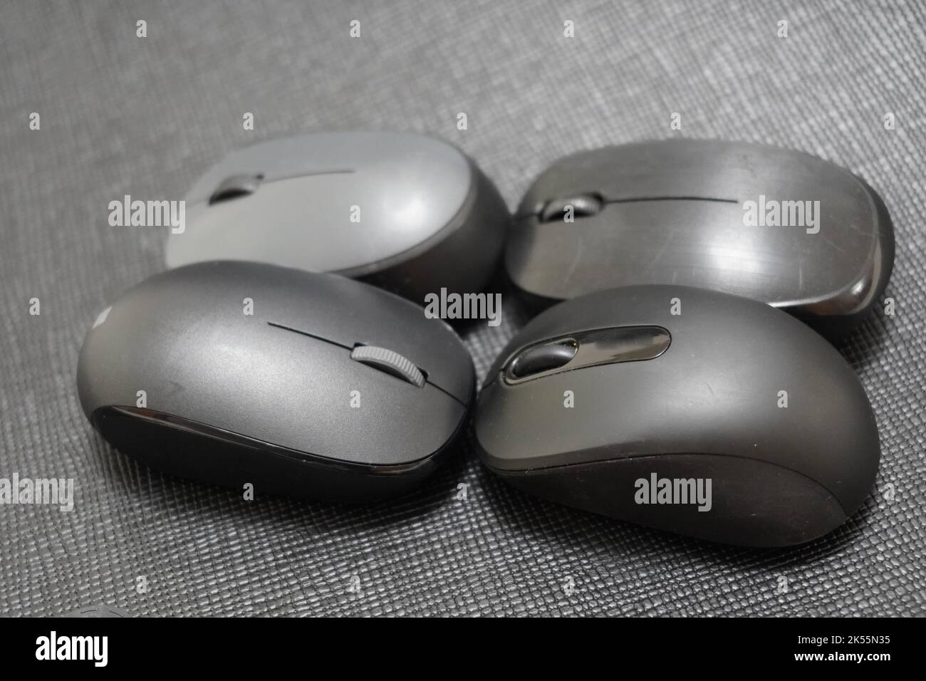 four different wireless mice on a black background Stock Photo - Alamy