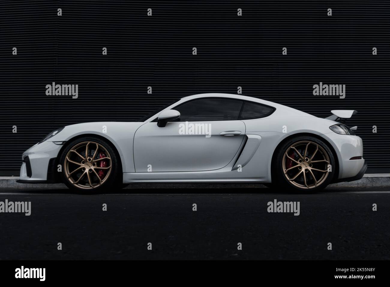 The Side Of A White Purple Porsche Cayman GT4 With Gold Alloy Wheels On ...