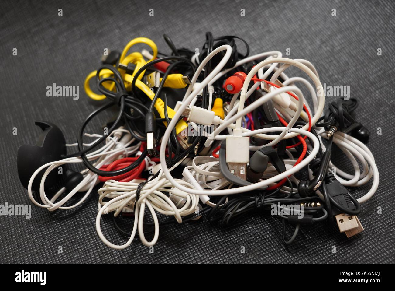 tangled cables of different types on a black background Stock Photo - Alamy