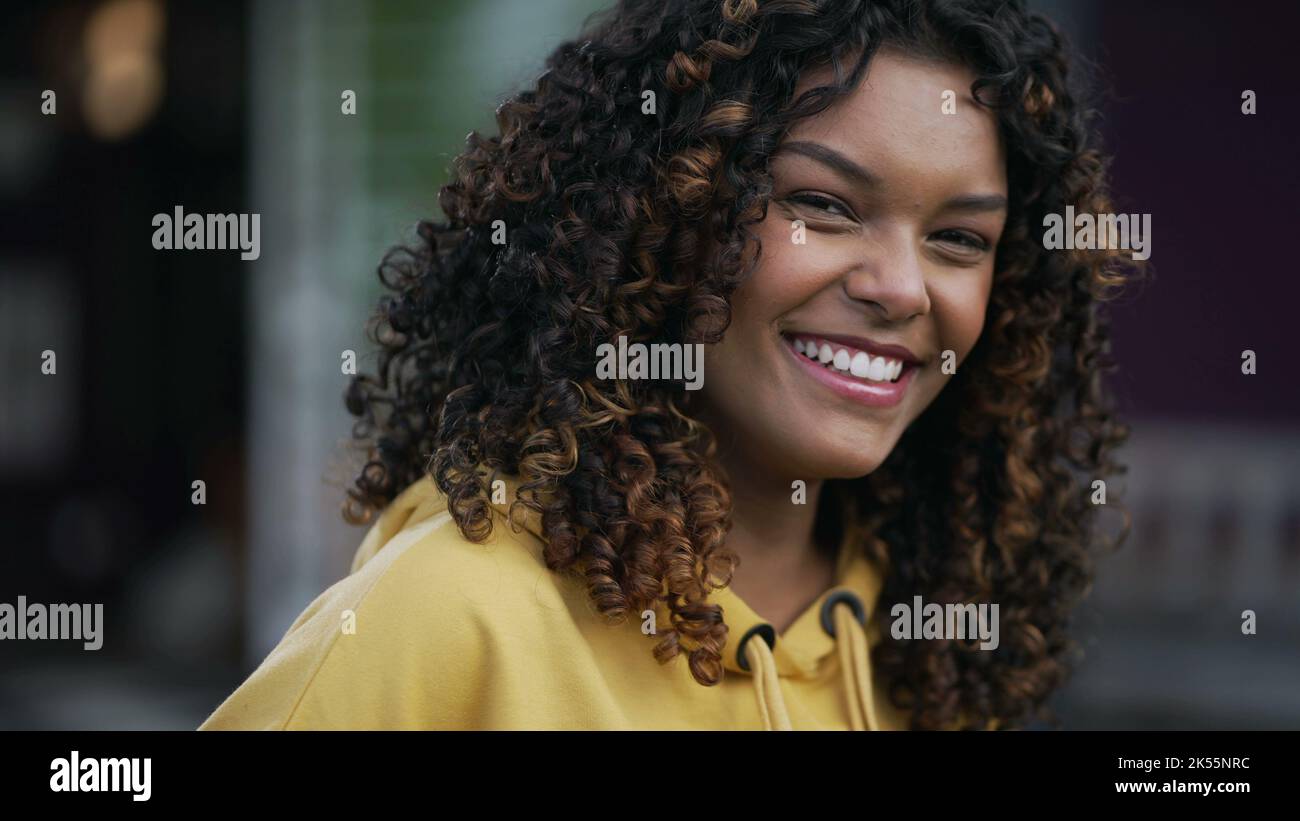Portrait of a happy black hispanic young woman looking at camera. Young ...