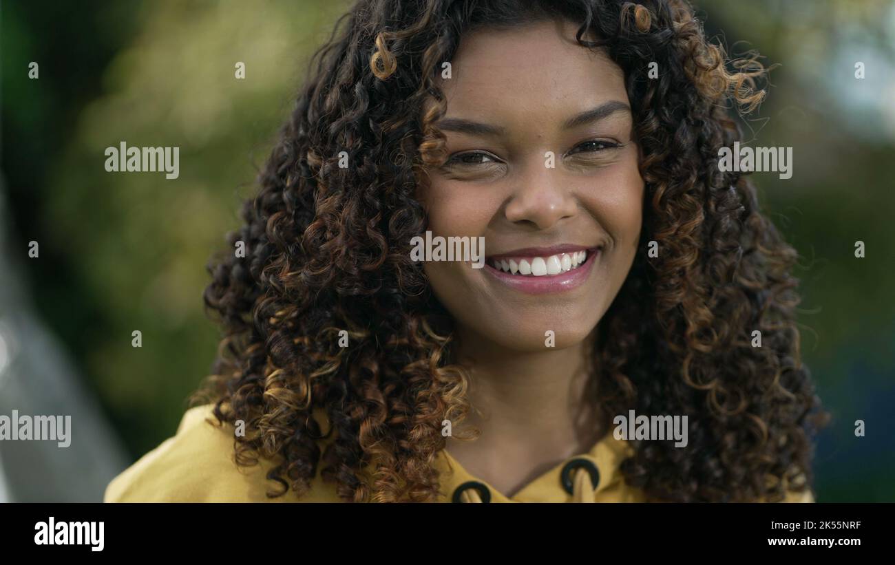 Portrait of a happy black hispanic young woman looking at camera. Young ...