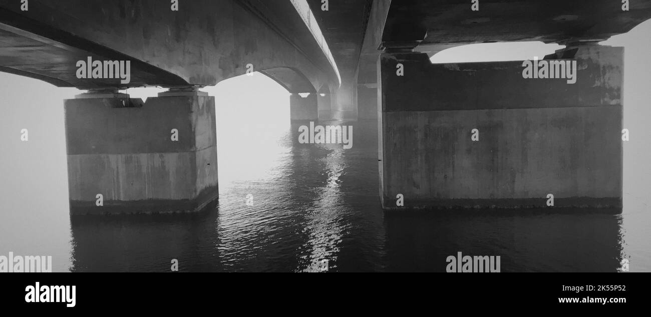 A beautiful panoramic shot of a bridge in foggy weather in Denmark ...