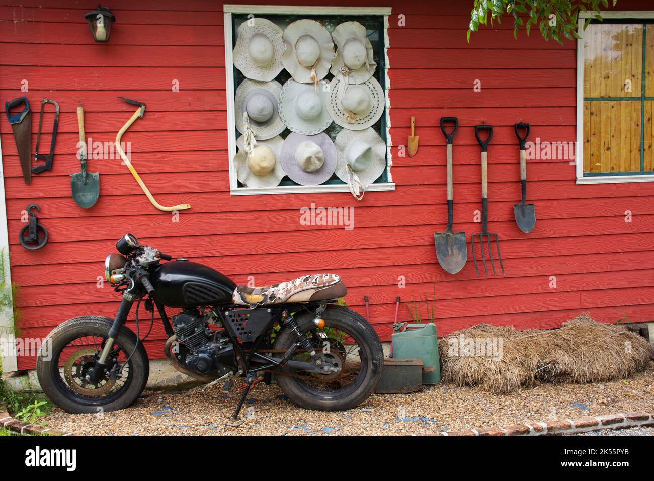 Tools and equipments farm gardening on red wooden wall of barn ...