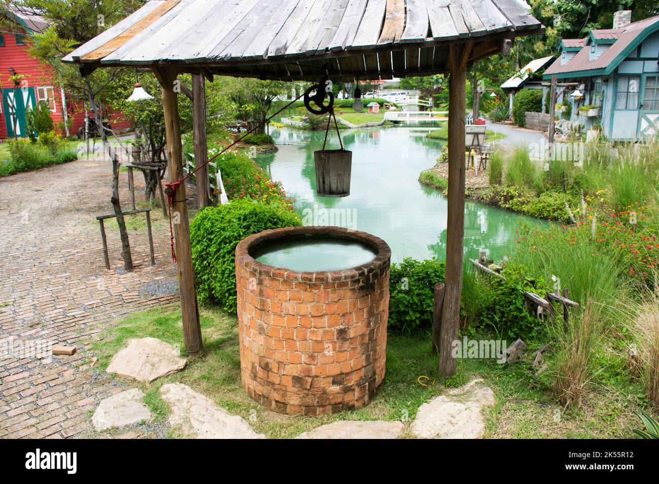 Classic vintage retro antique stone brick artesian water well and roof ...